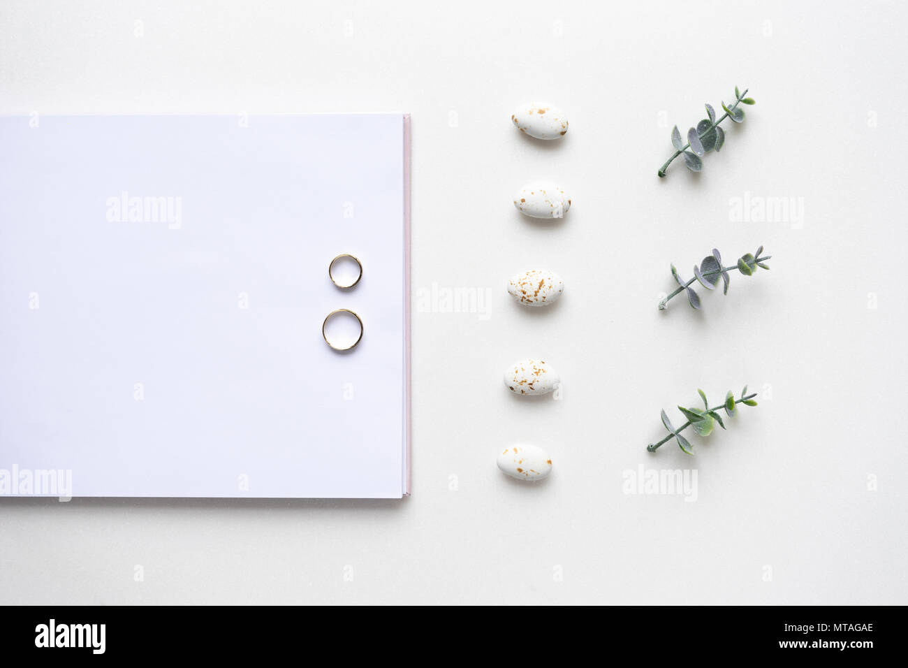 Wedding wish book, rings, candy and oregano branches on white marble ...