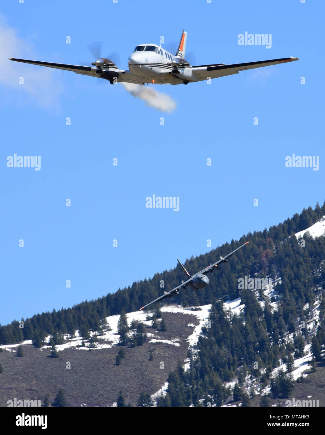 A U.S Forest Service Lead Plane leaves a trail of white smoke to ...