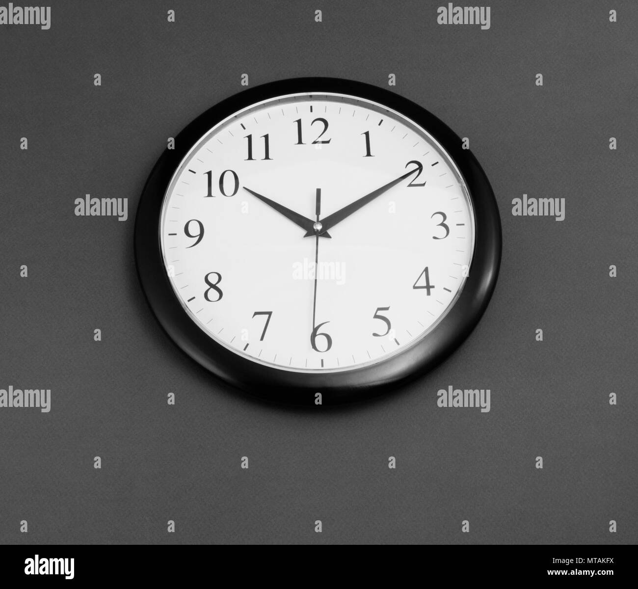 Classic clock on gray background Stock Photo - Alamy