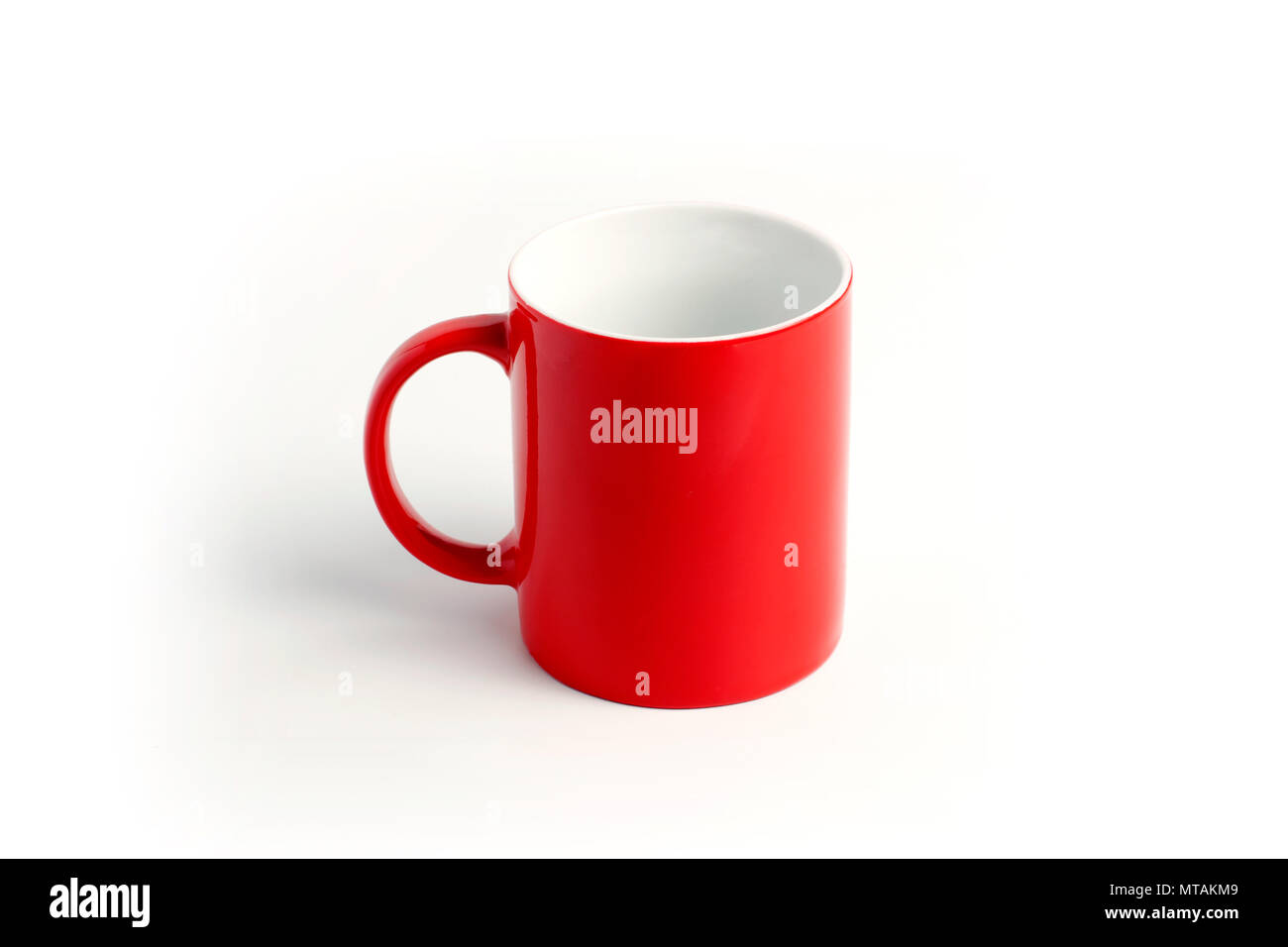 Empty red mug on a white background Stock Photo - Alamy