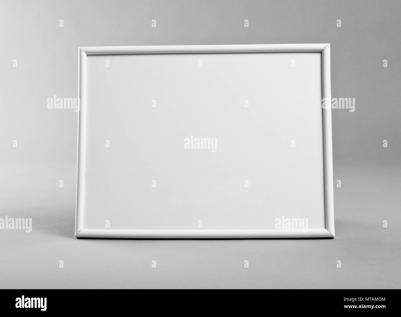 White horizontal frame for paintings or photographs on gray background ...