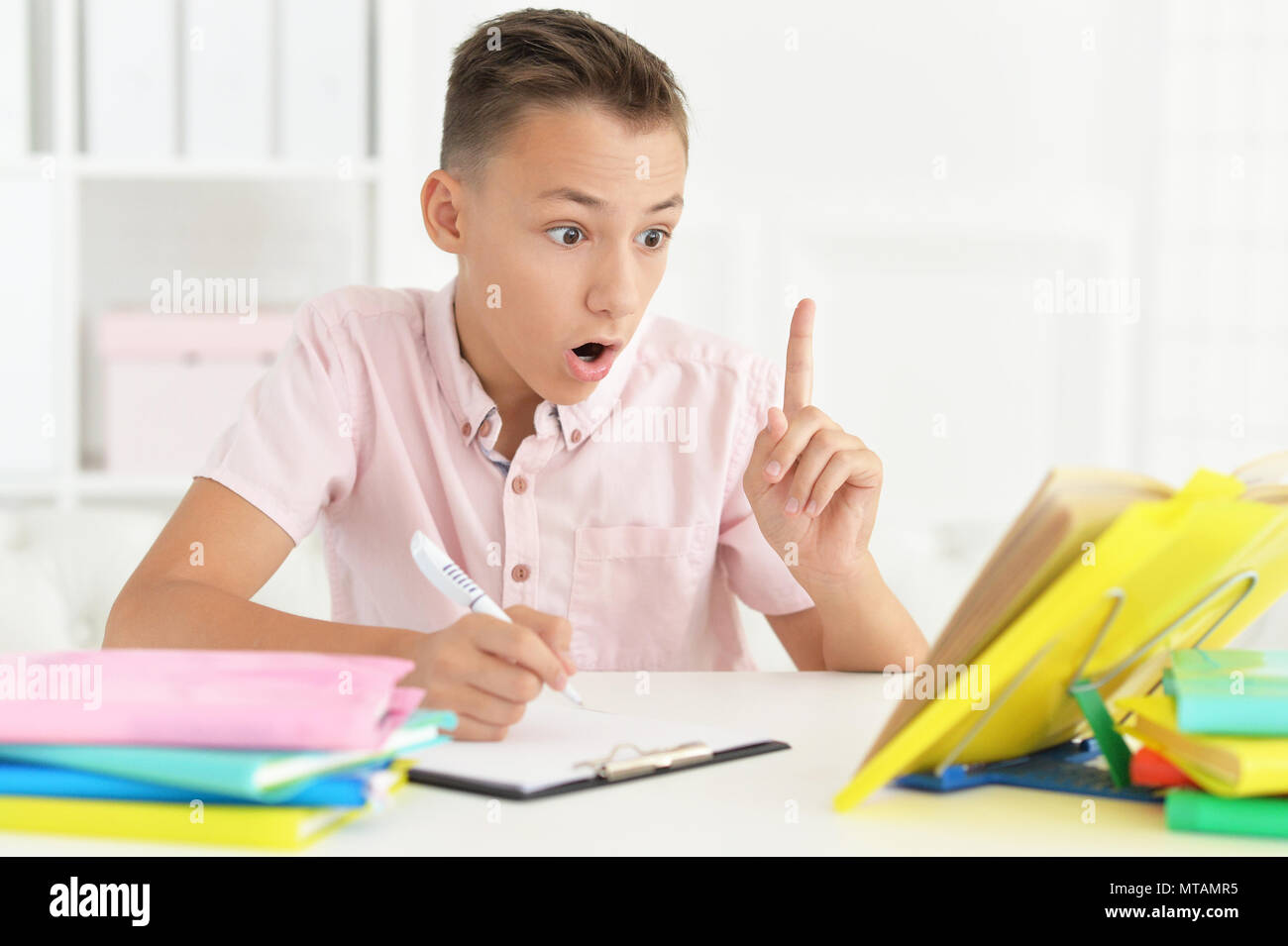 Young boy doing homework Stock Photo - Alamy