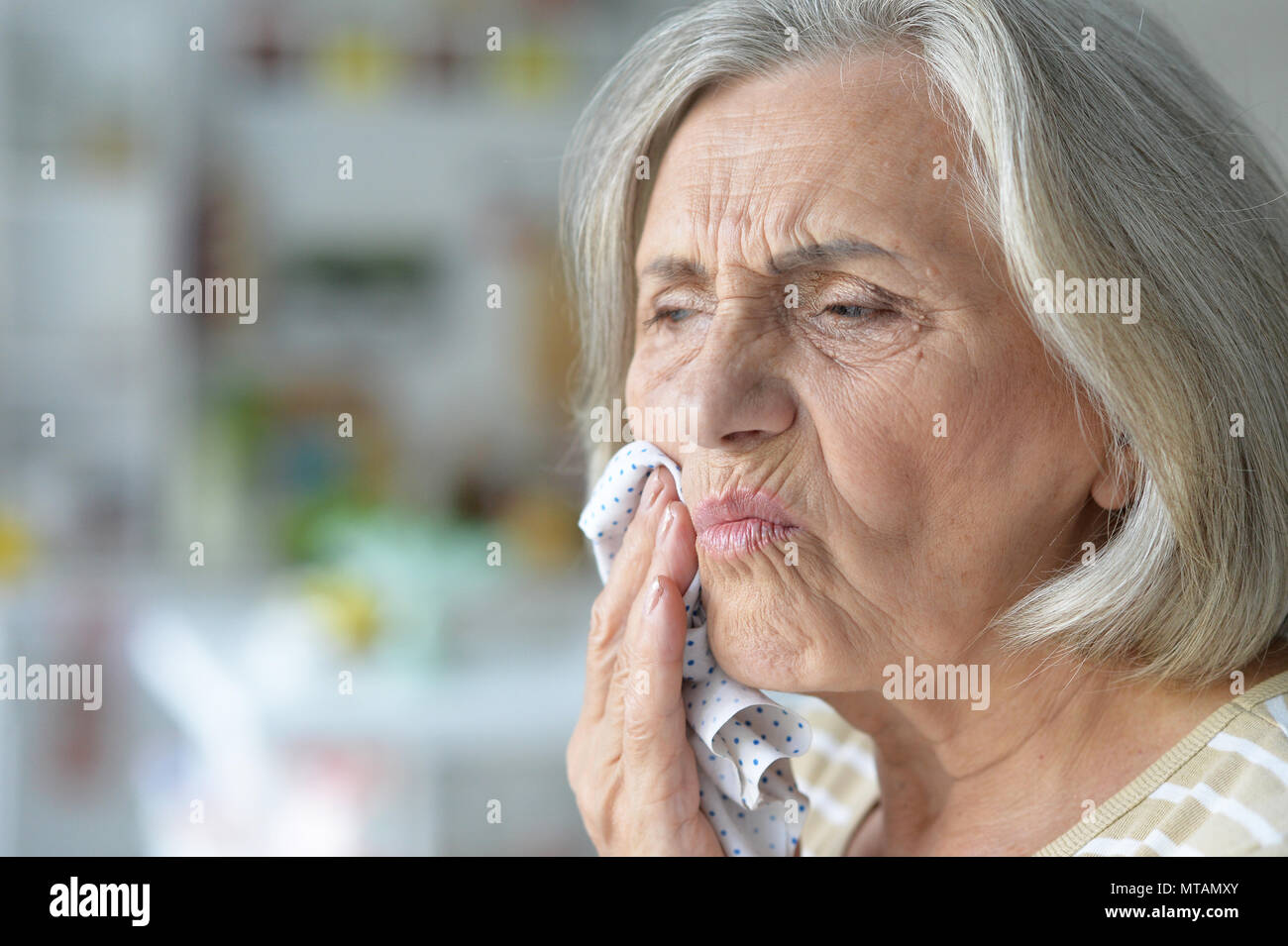 Senior woman with toothache Stock Photo - Alamy