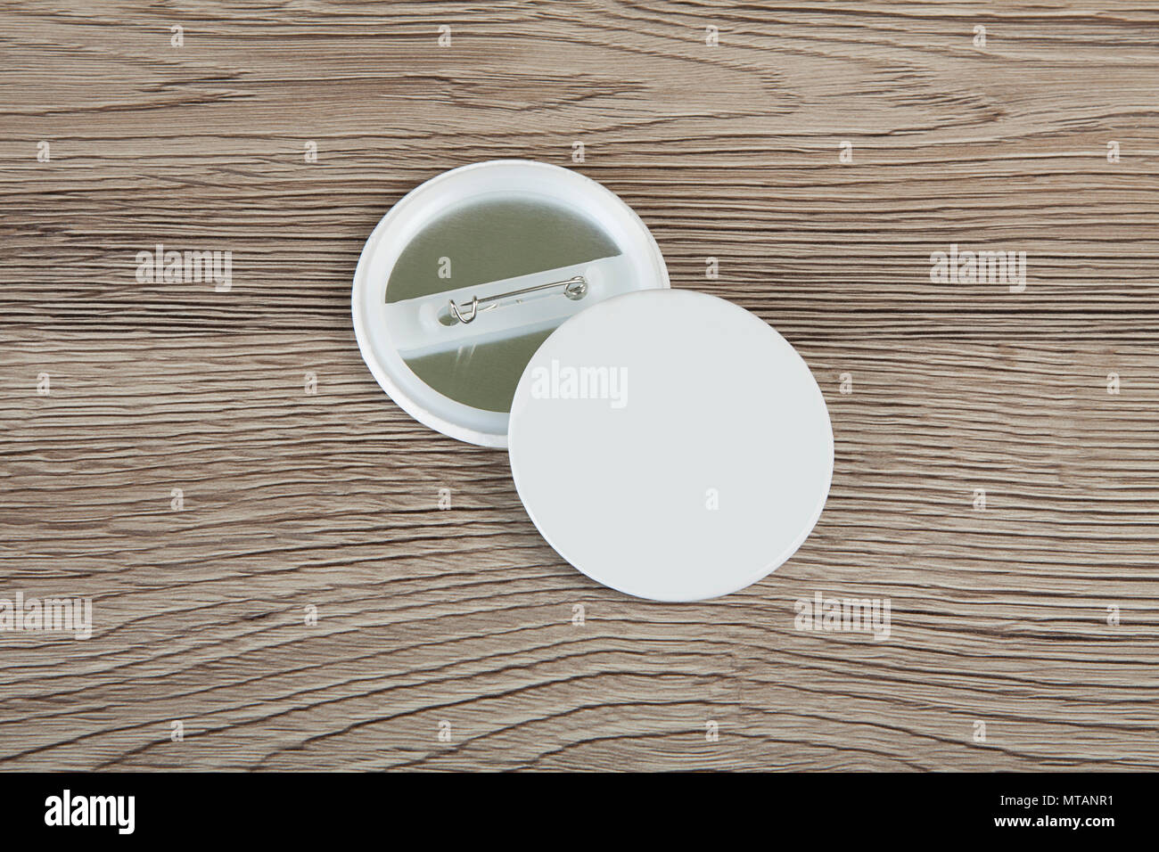 White Badges front and back view on a wooden background Stock Photo - Alamy