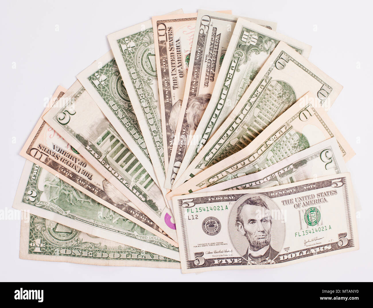 Pile of various US american dollar money bills spread on white ...