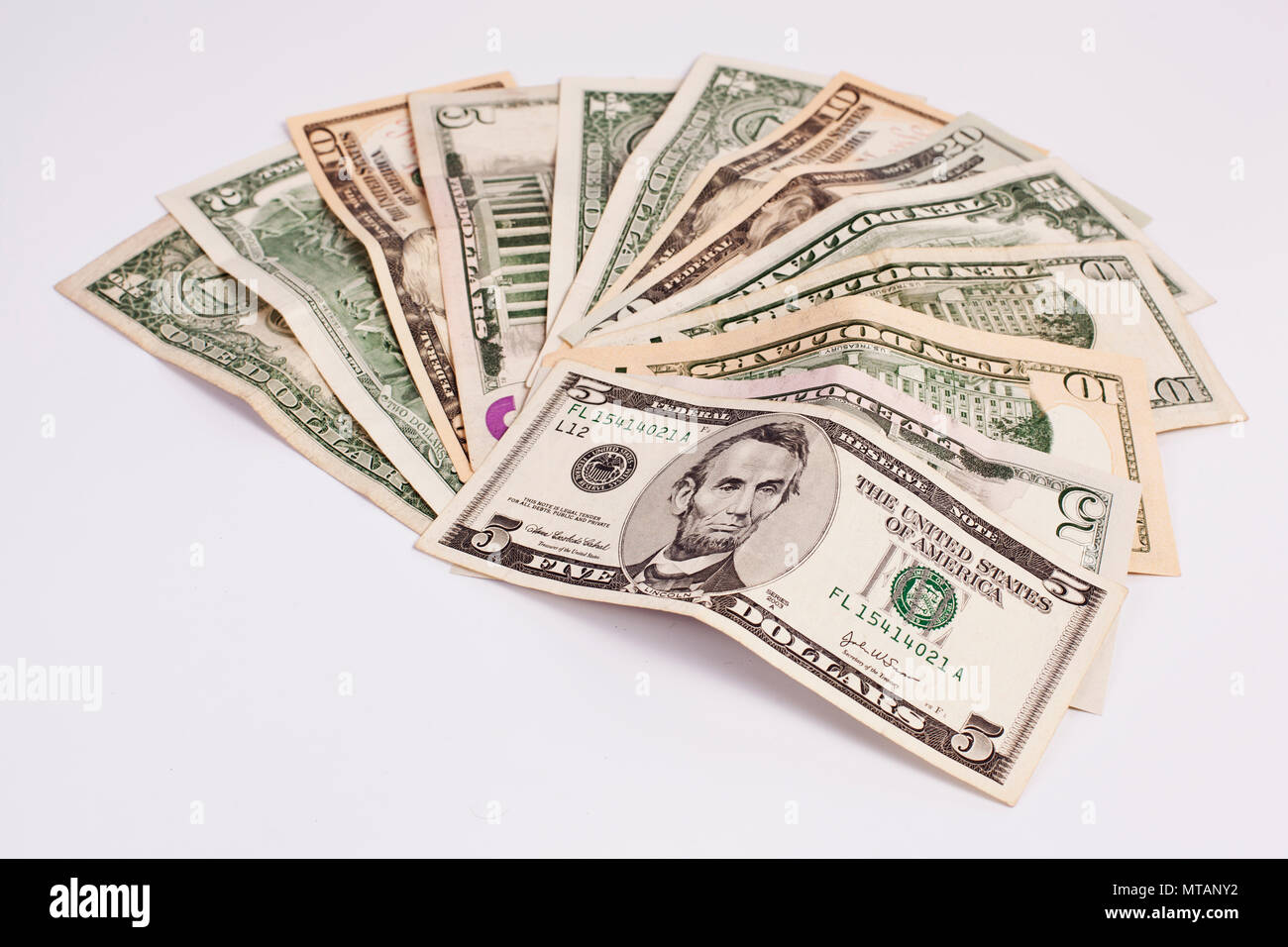Pile of various US american dollar money bills spread on white ...