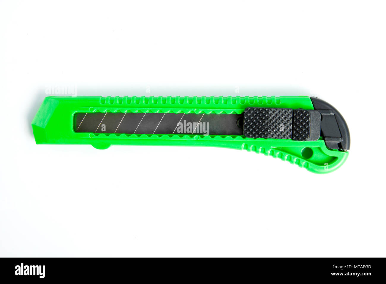 Green stationery knife isolated on a white background. Closed paper ...