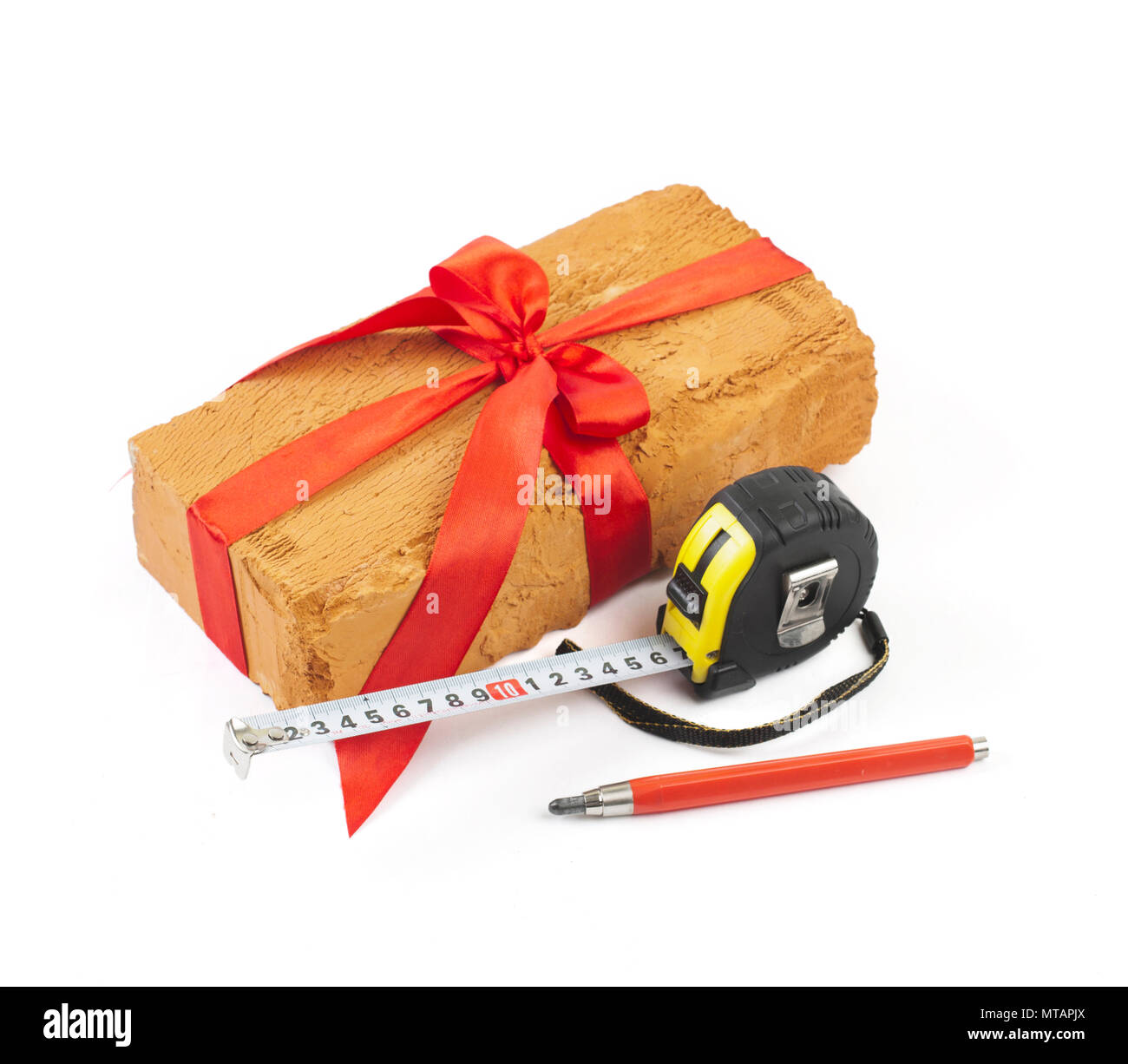 One brick, a ruler, a pencil a white background Stock Photo - Alamy