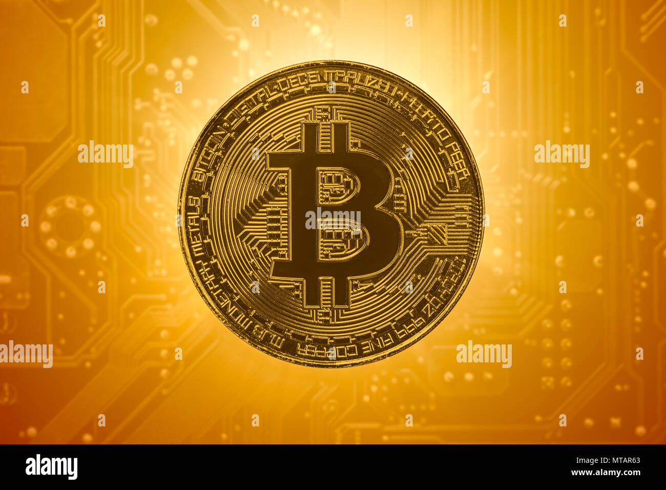 Gold color Bitcoin coin on computer electronic circuit board golden ...