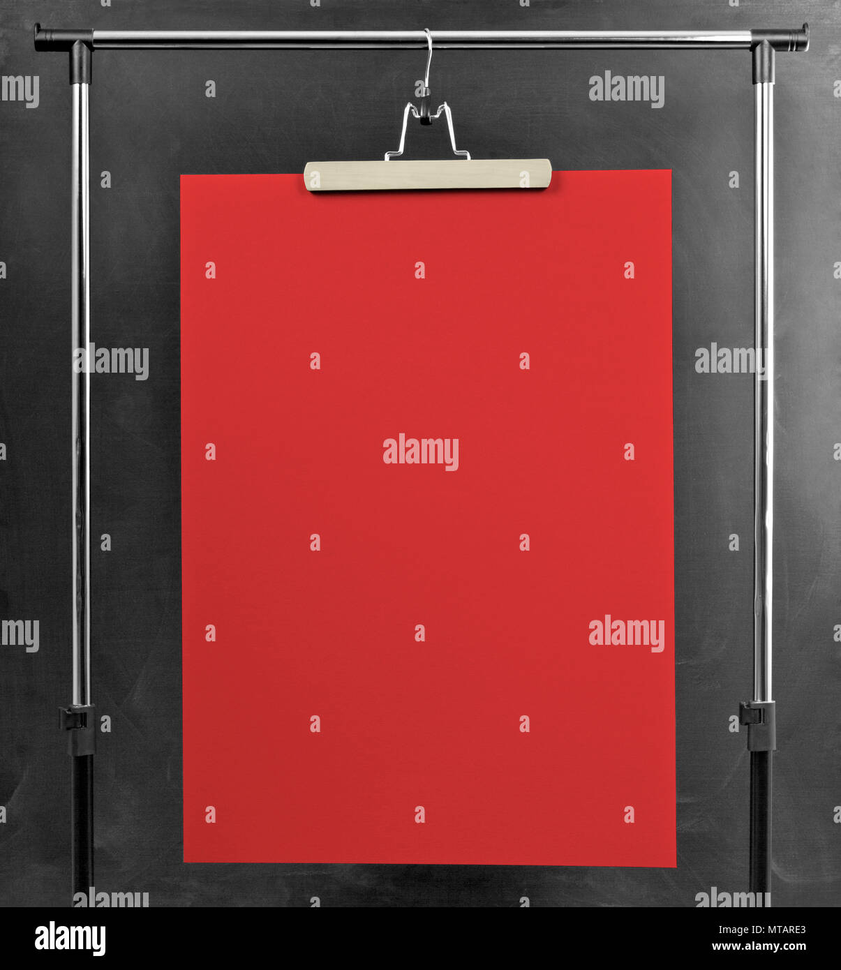 Red poster hanging at a clothes rack Stock Photo - Alamy