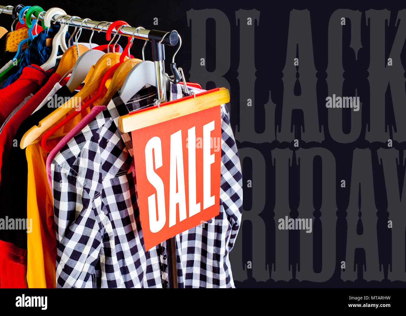 Sale in a clothing store - discount sign at a clothes rack Stock Photo ...