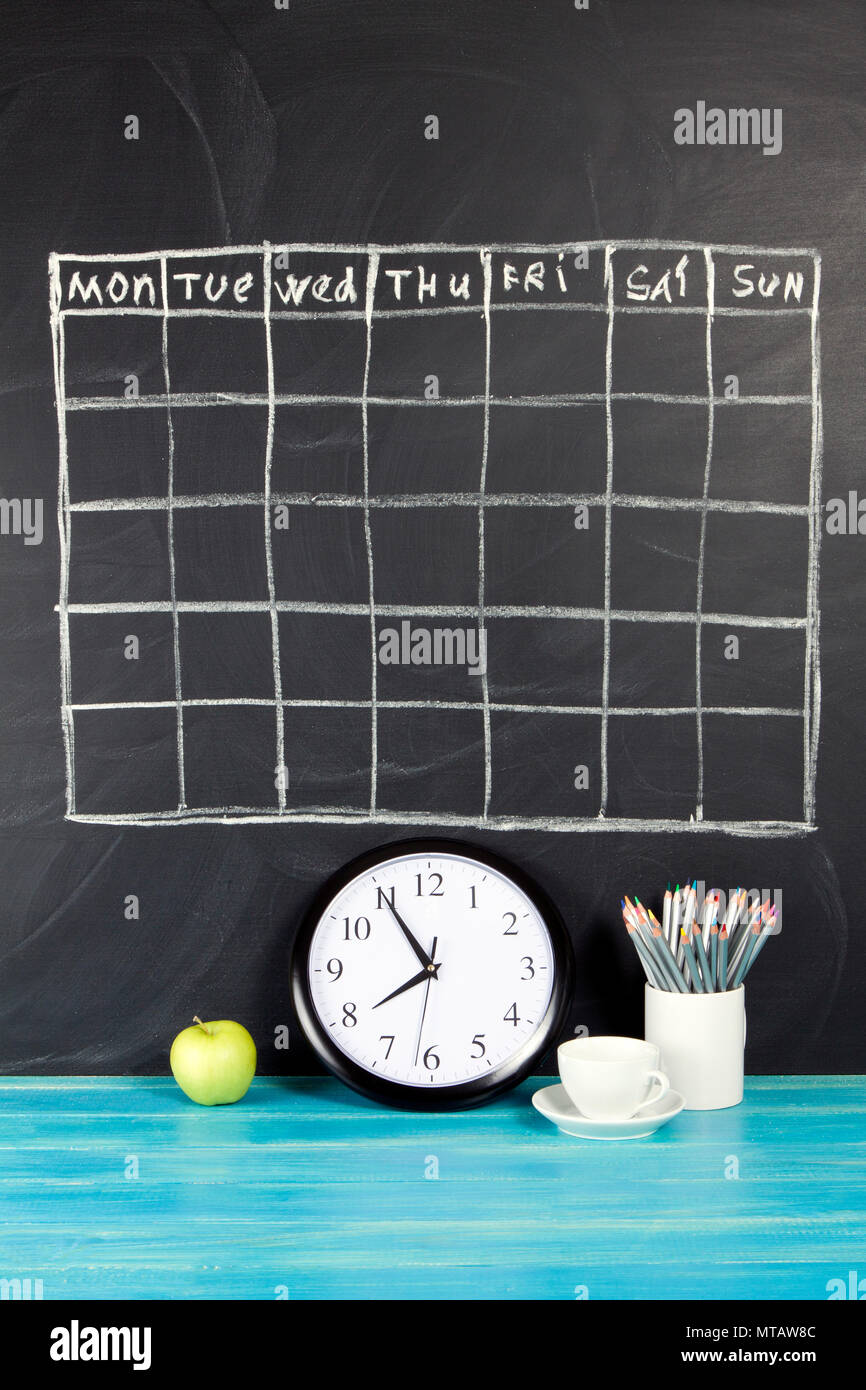 Grid timetable schedule on black chalkboard background Stock Photo - Alamy