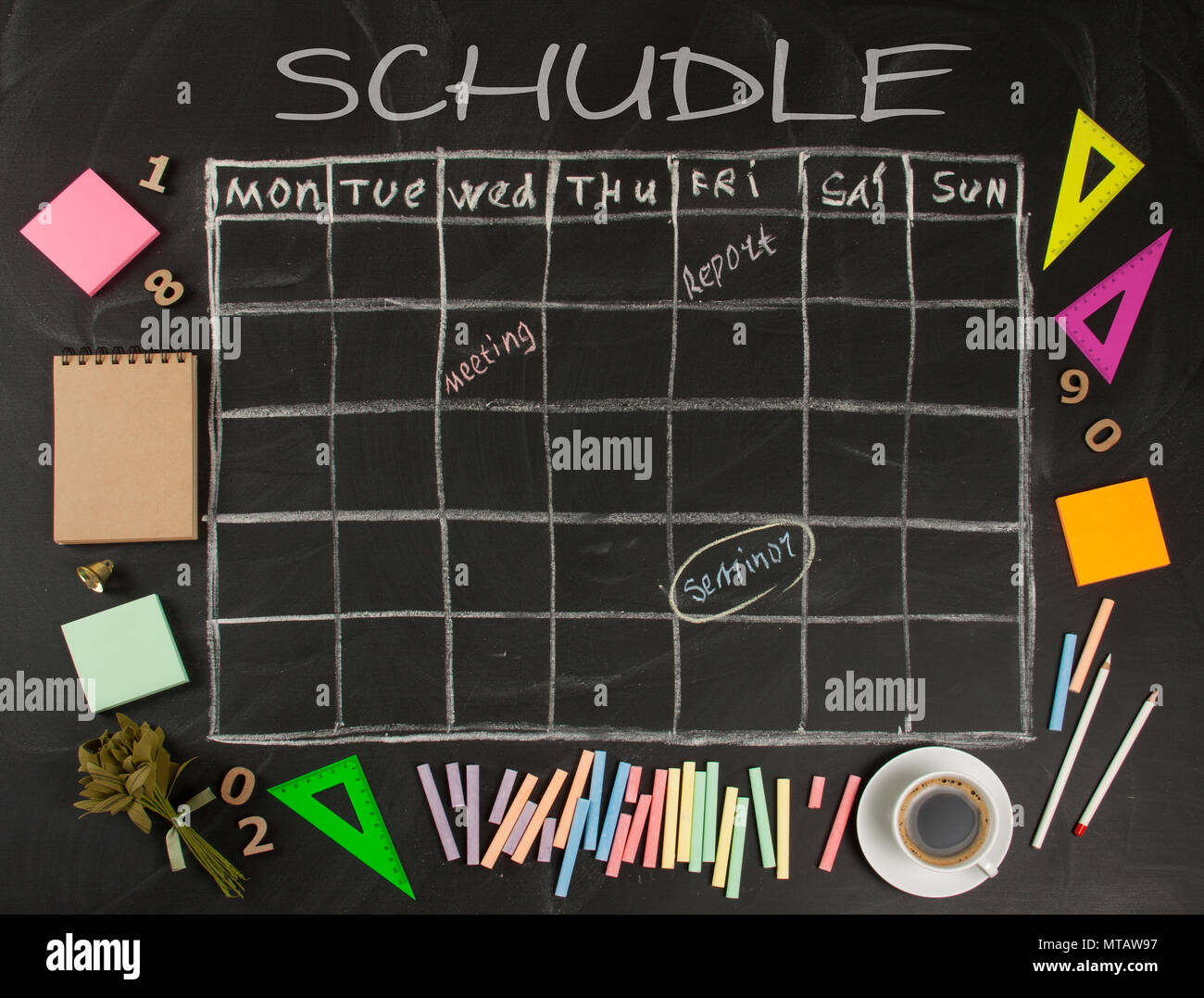 Grid timetable schedule with stationery on black chalkboard background ...