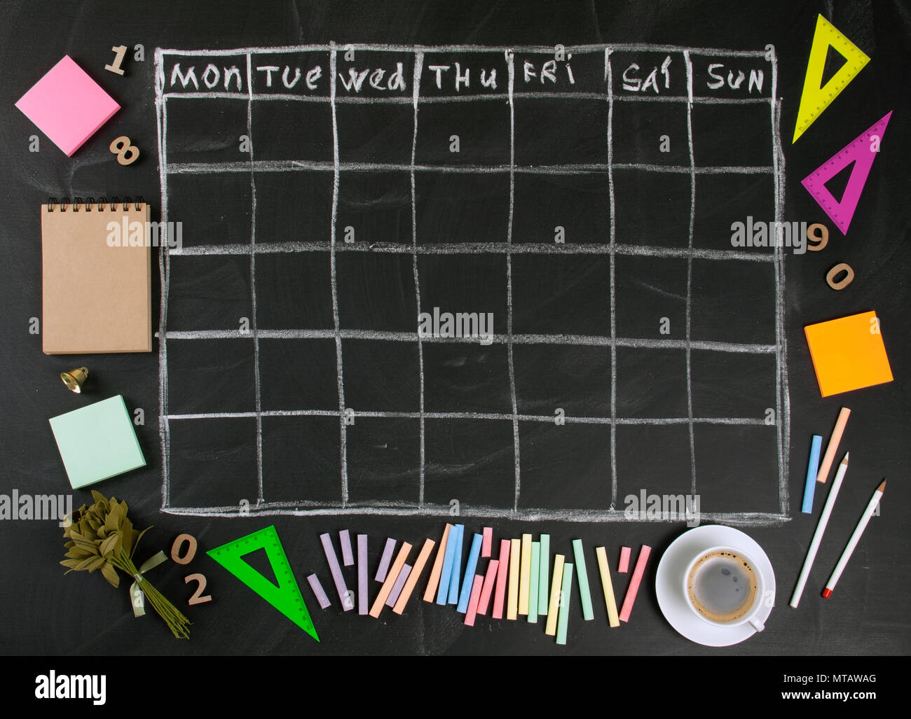 Grid timetable schedule with stationery on black chalkboard background ...