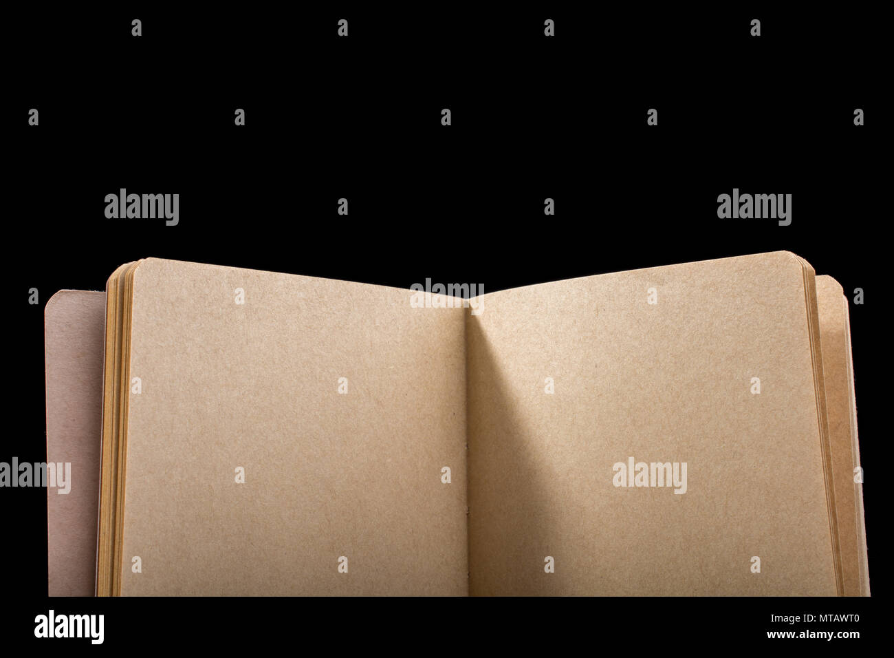 Brown color notebook open on a black background Stock Photo - Alamy