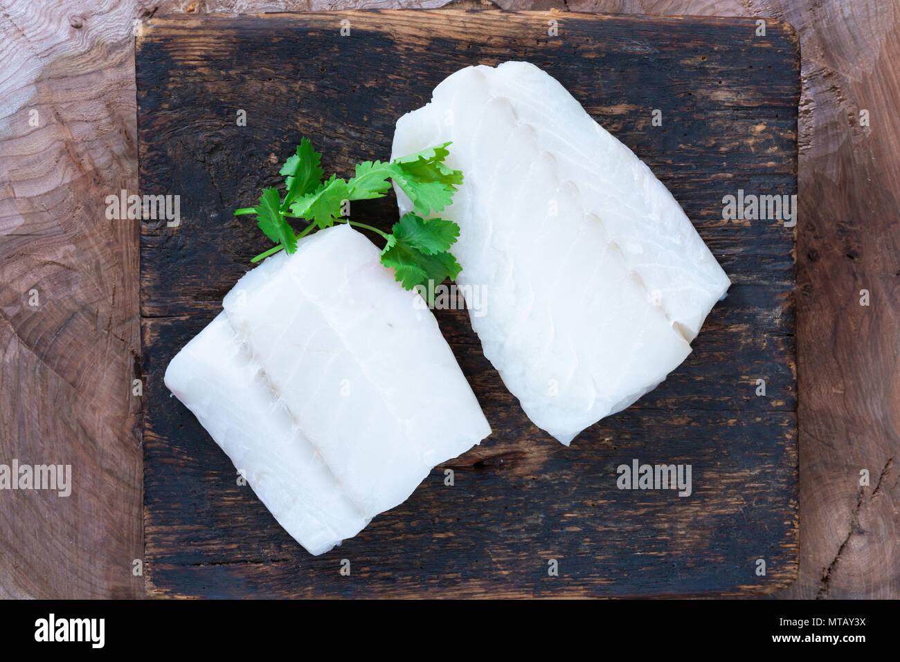 Row cod fillets on woode board - top view Stock Photo - Alamy