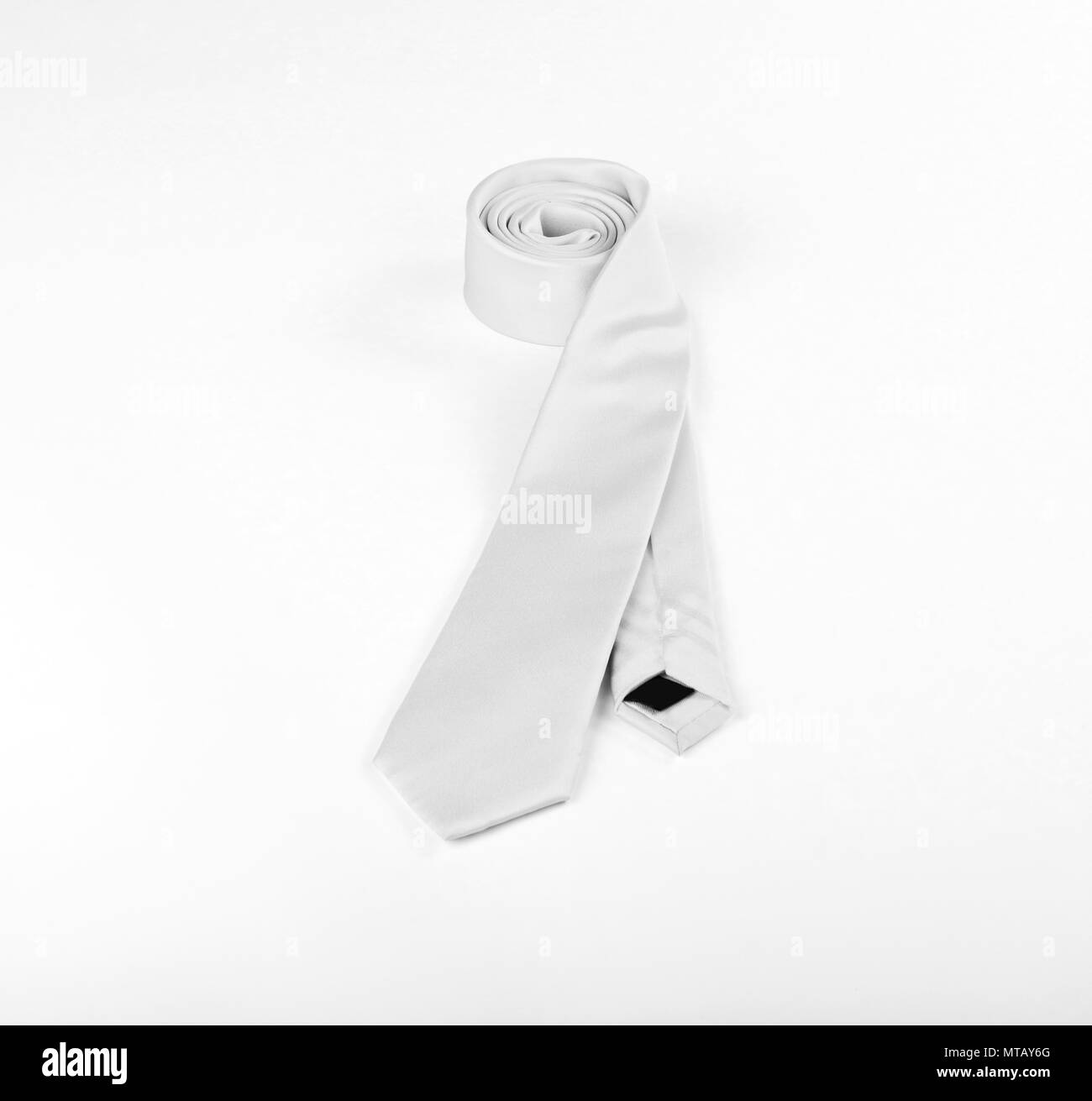 White necktie on white background, roll of necktie on white background ...