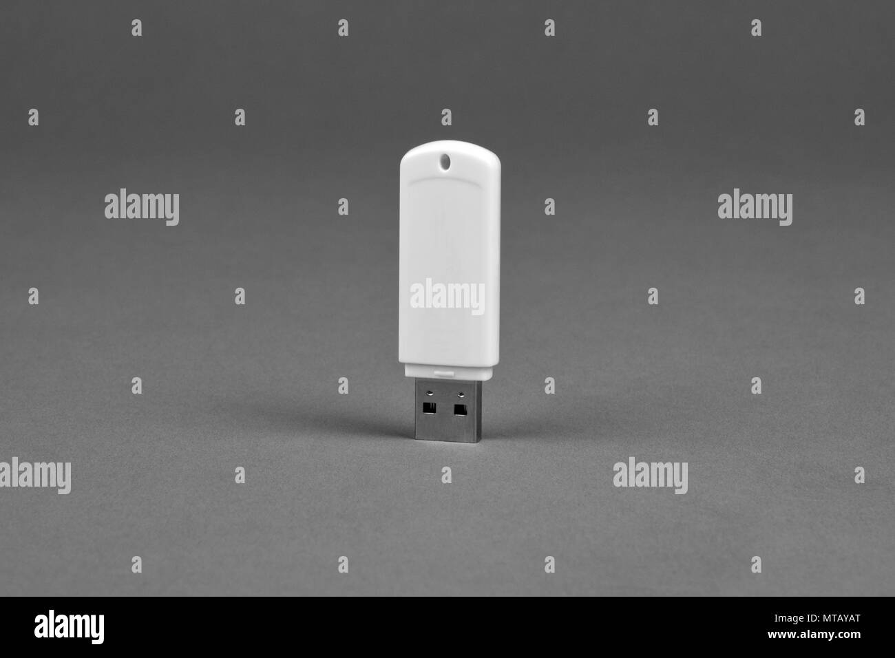 White usb flash drive on gray background Stock Photo - Alamy