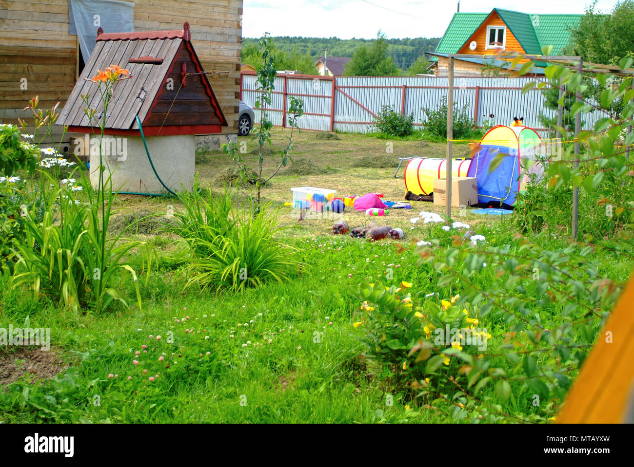 children's toys in the courtyard of a rural house in the evening ...