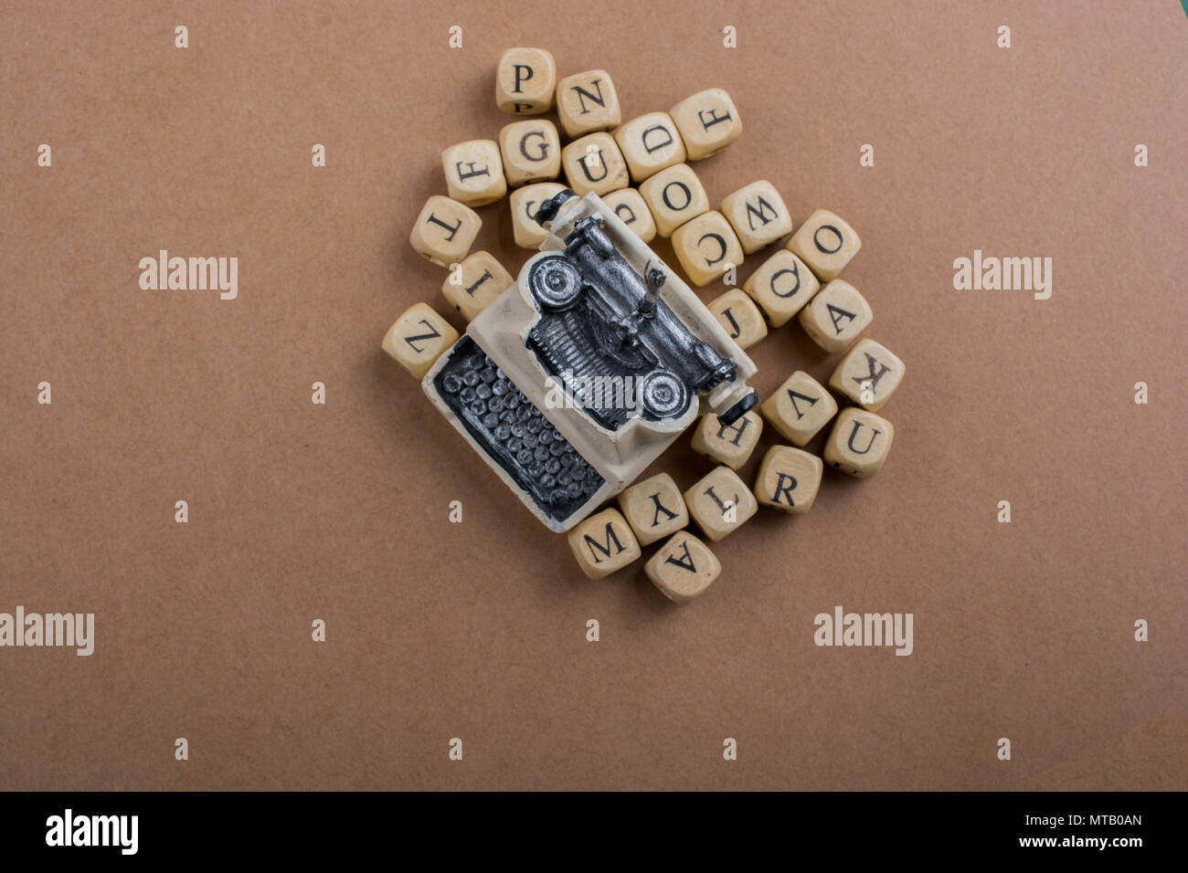 Letter cubes of made of wood around model typewritter Stock Photo - Alamy