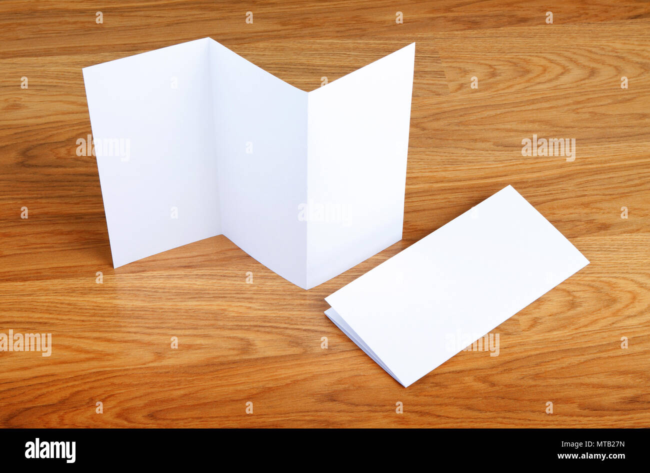 Blank folding page booklet on wooden background Stock Photo - Alamy
