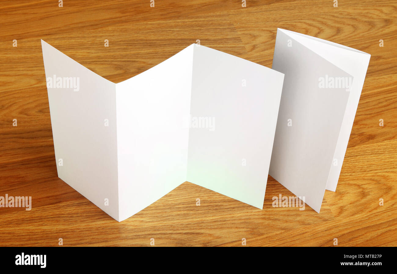 Blank folding page booklet on wooden background Stock Photo - Alamy