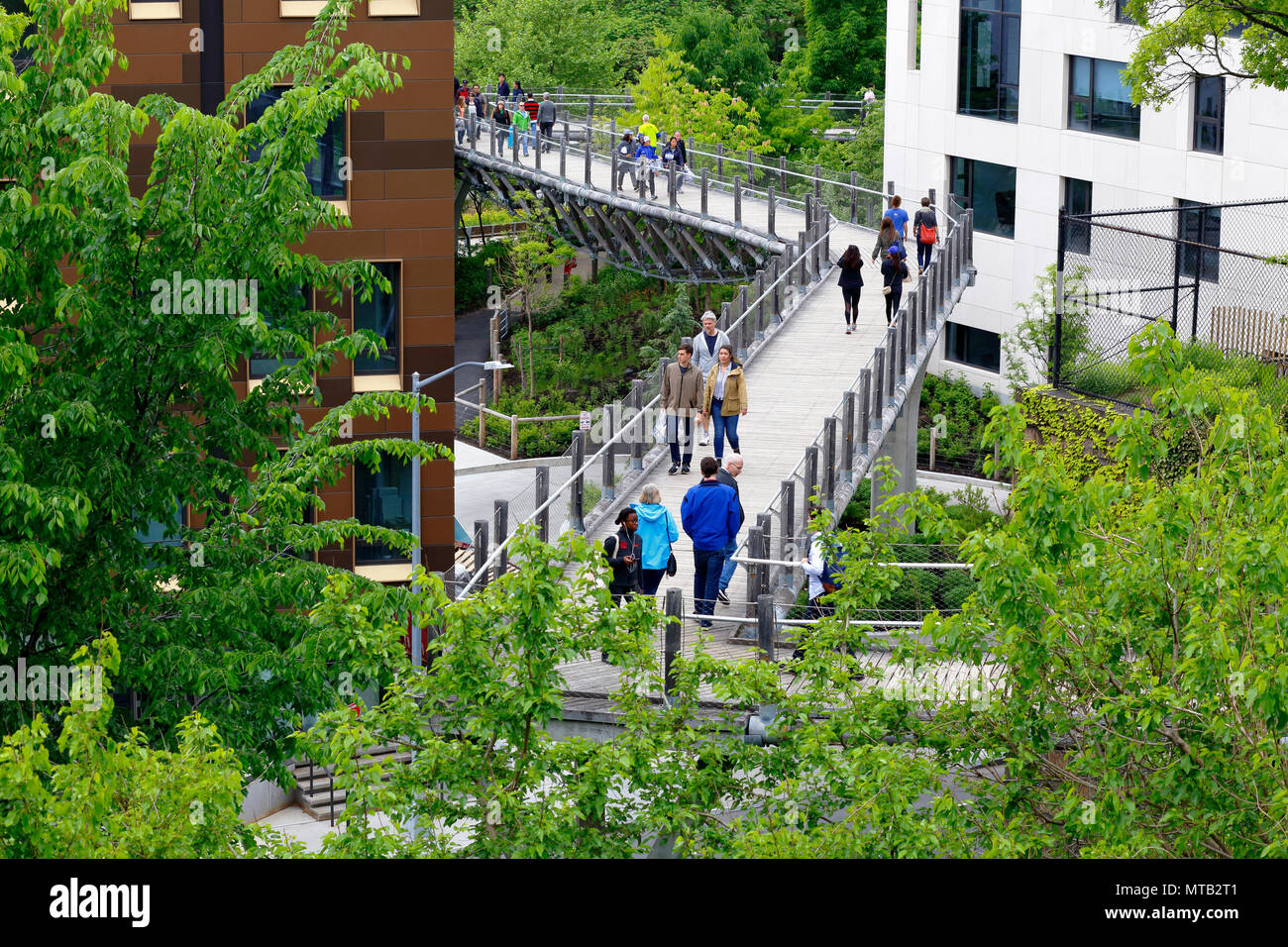 People walking across the Squibb Park Bridge over Brooklyn Bridge Park ...