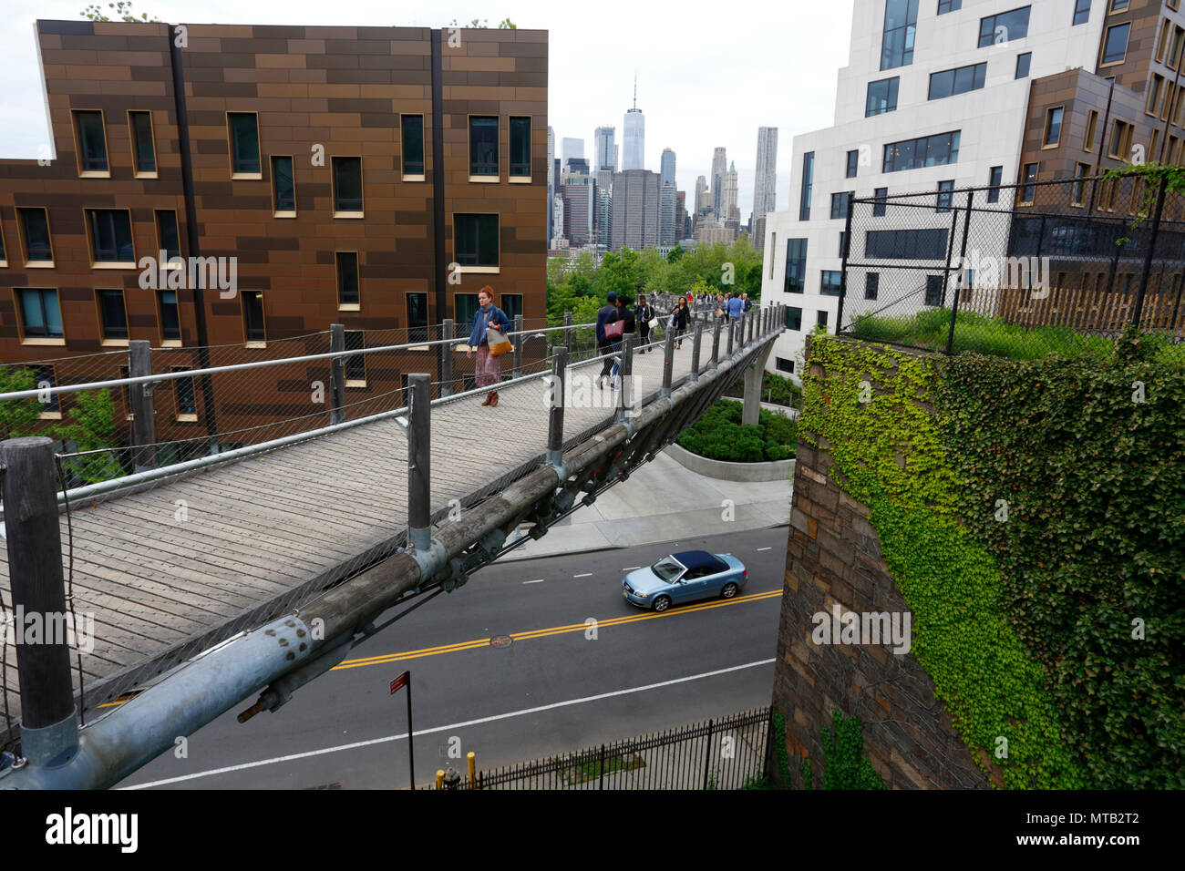 People walking across the Squibb Park Bridge over Brooklyn Bridge Park ...