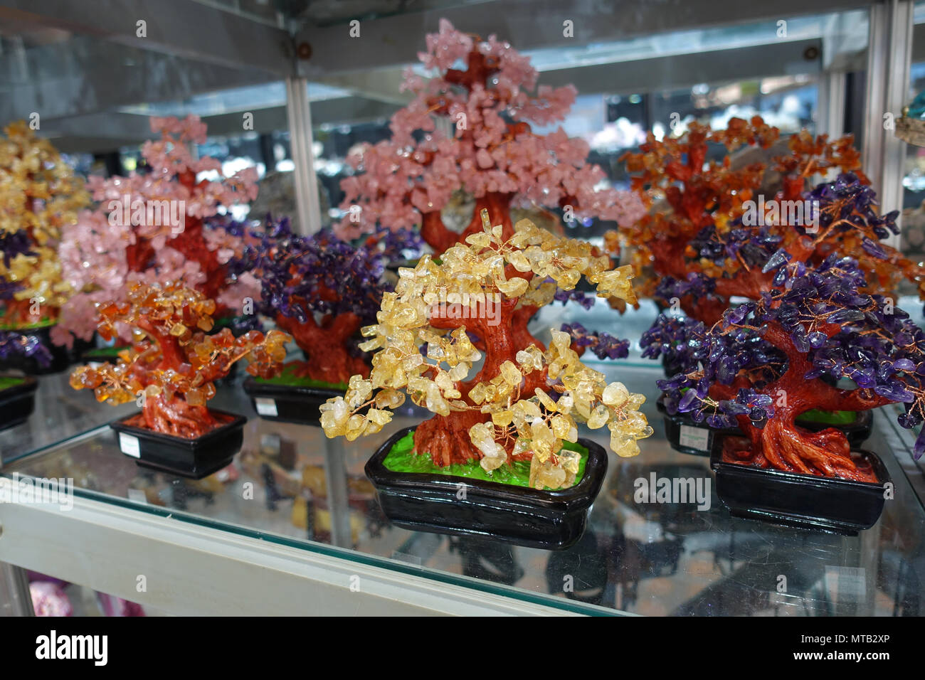 Colourful crystal gemstone trees on display Stock Photo - Alamy