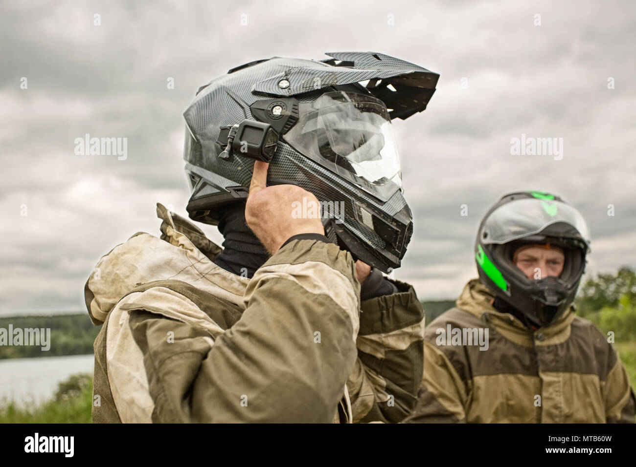 Two men outdoors wearing motorcycle helmets and uniforms Stock Photo ...