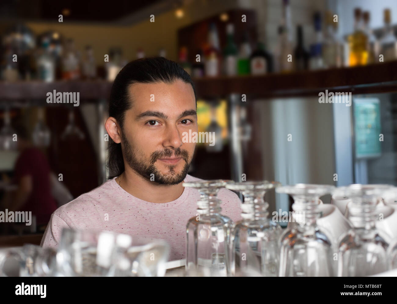Portrait of handsome young smiling bartender behind the bar coun Stock ...