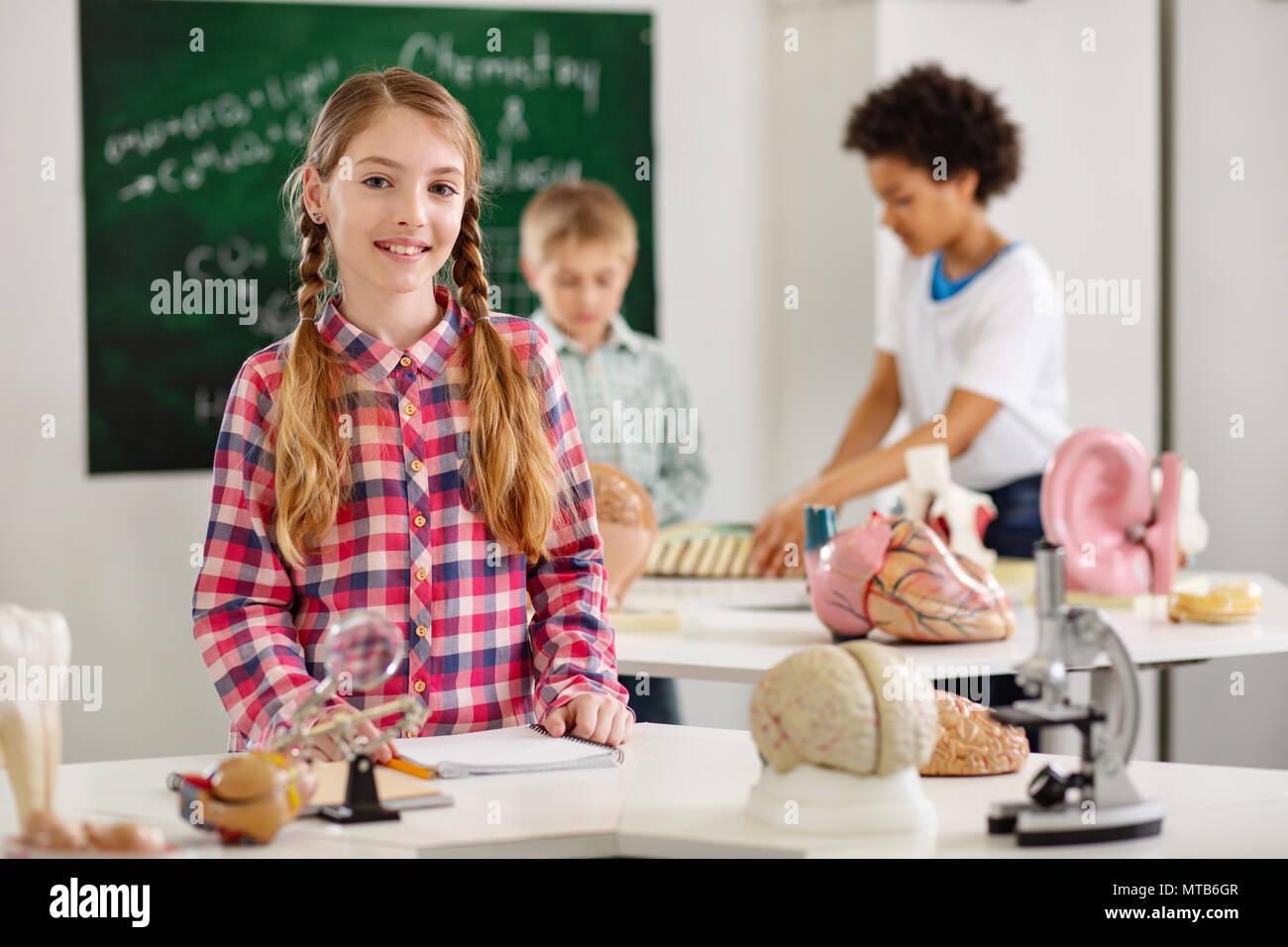 Nice young girl studying biology Stock Photo - Alamy