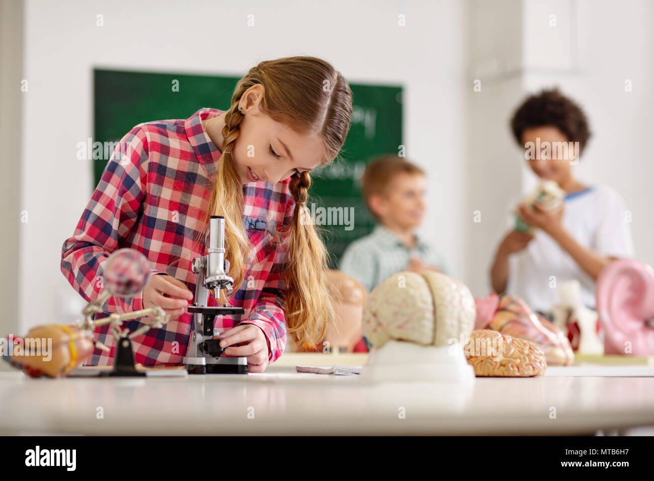 Smart curious girl looking into the microscope Stock Photo - Alamy