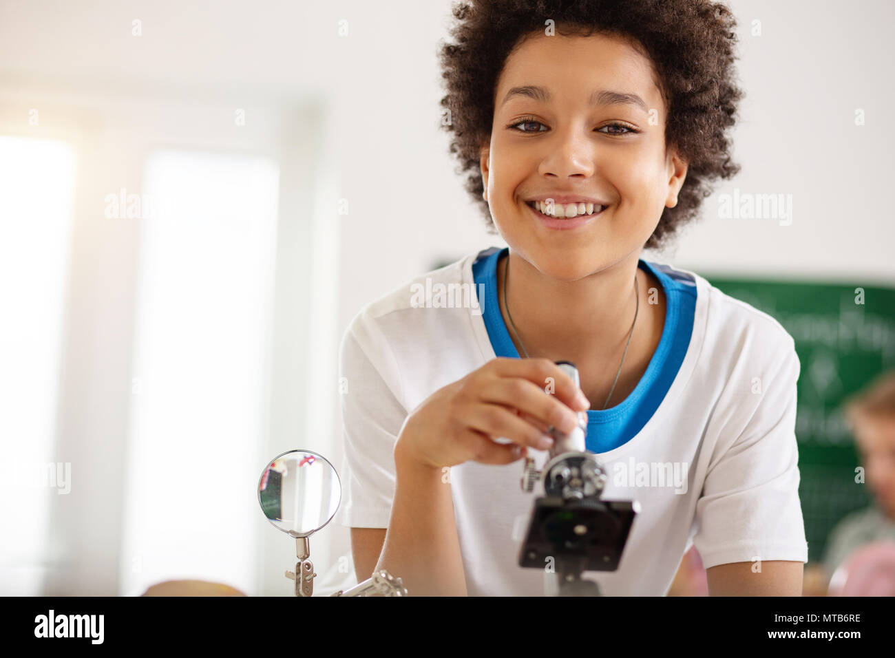 Cheerful positive boy smiling to you Stock Photo - Alamy