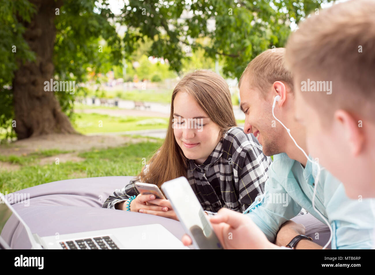 Three young people chilling hi-res stock photography and images - Alamy