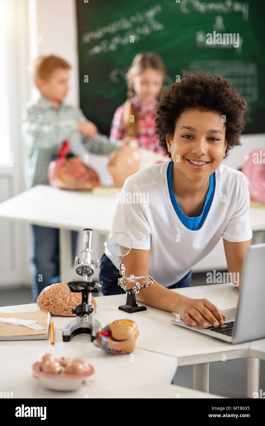 Cheerful happy boy enjoying the class Stock Photo - Alamy