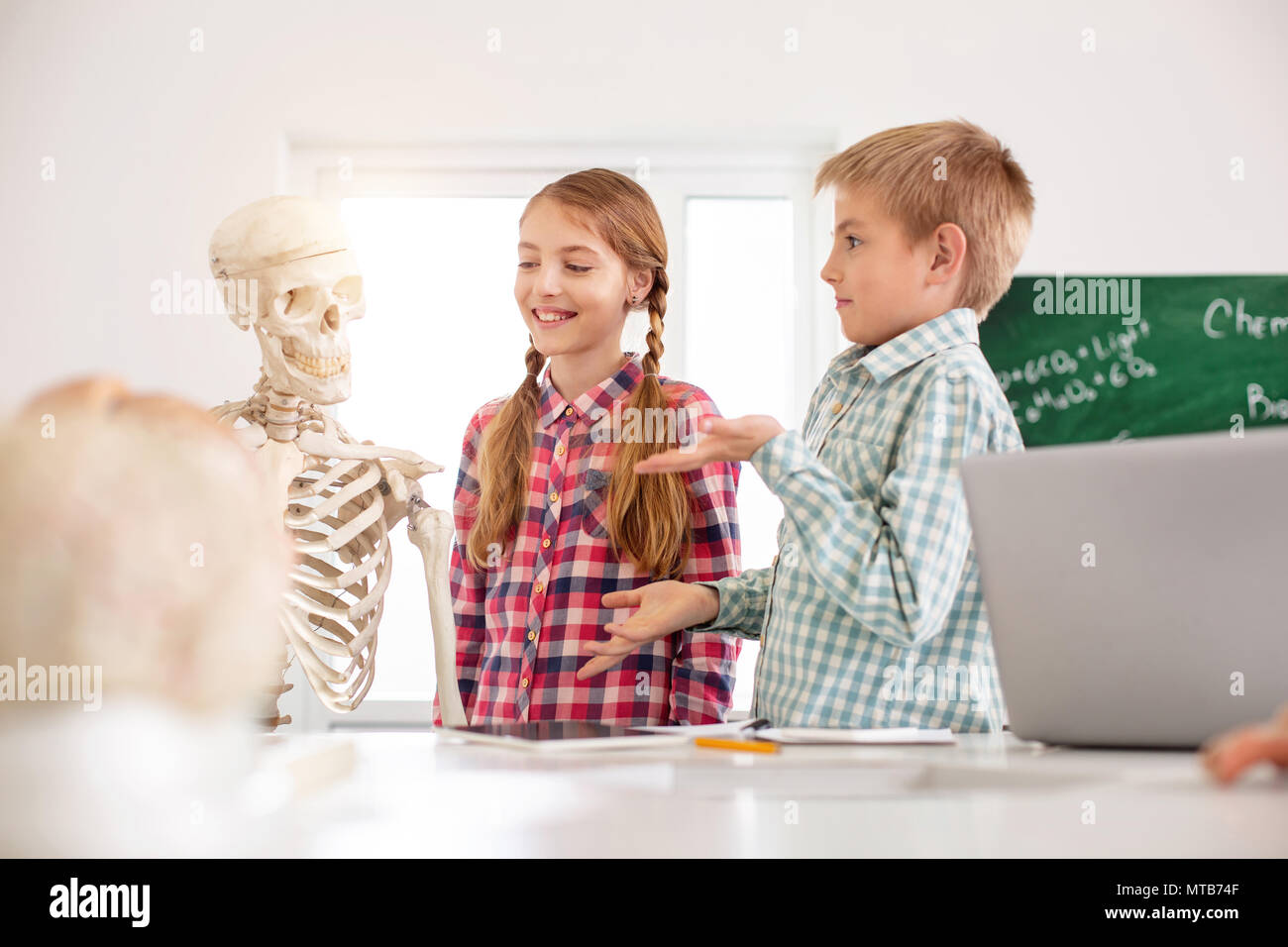 Joyful positive children talking to each other Stock Photo - Alamy