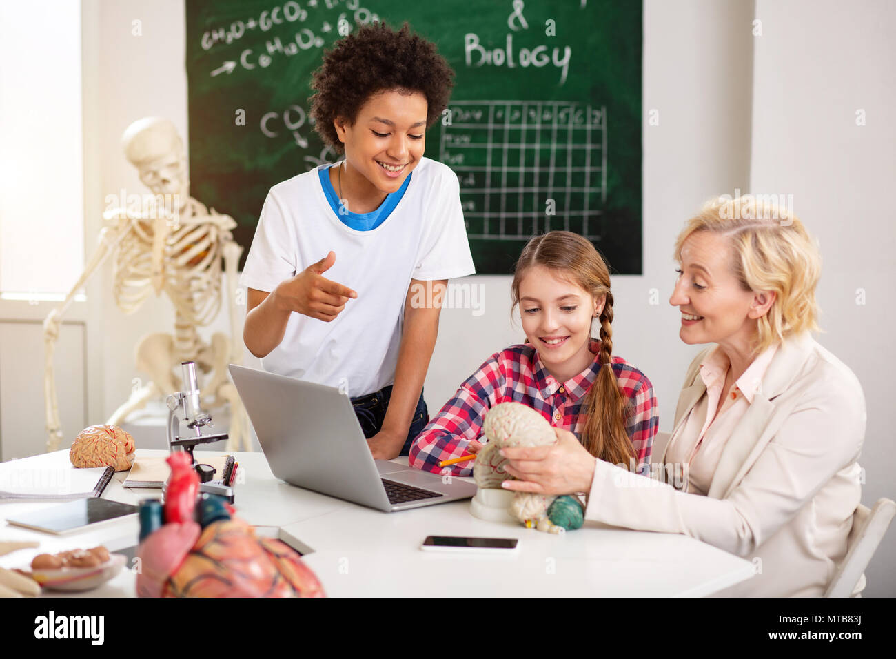 Cheerful positive boy pointing at the brain model Stock Photo - Alamy