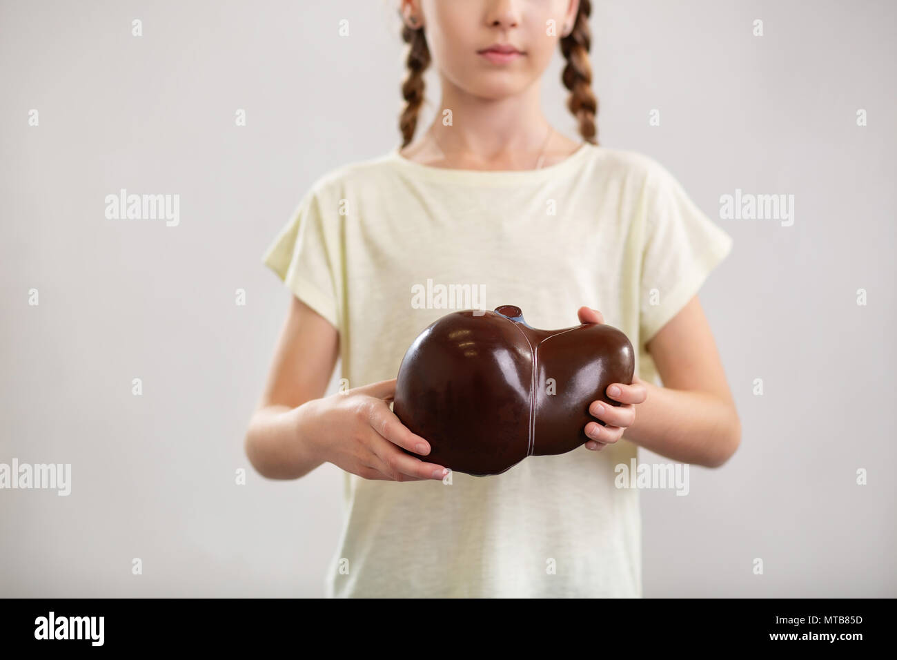 Nice young girl holding a human liver Stock Photo - Alamy