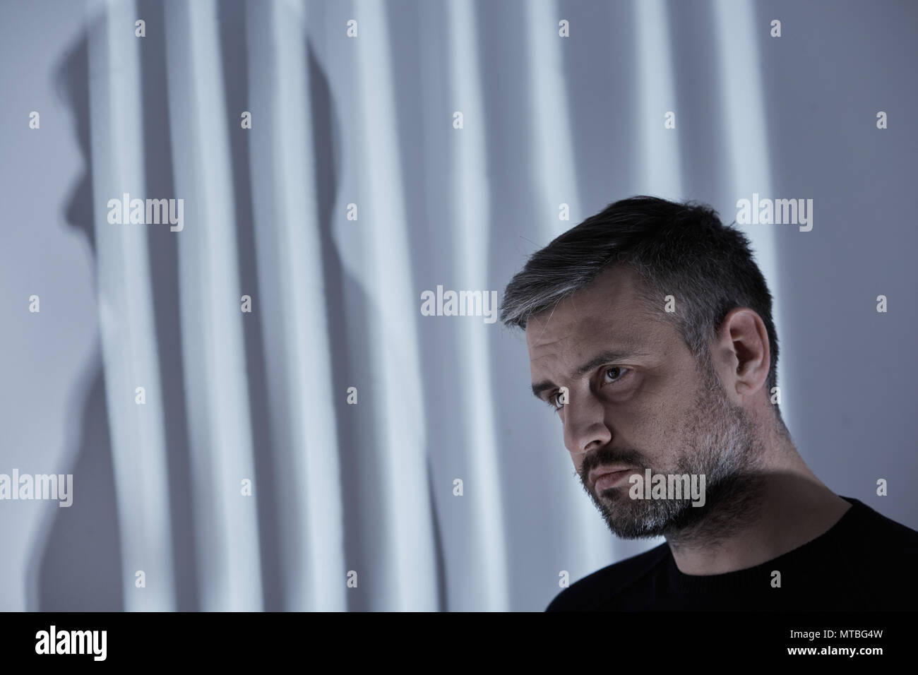 Broken man with depression in room interior Stock Photo - Alamy