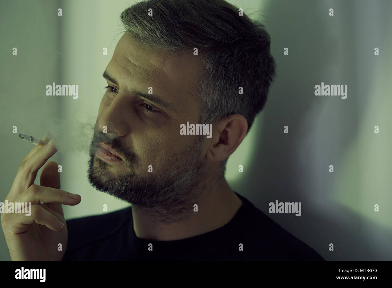 Addicted and depressed man smoking cigarette alone Stock Photo - Alamy
