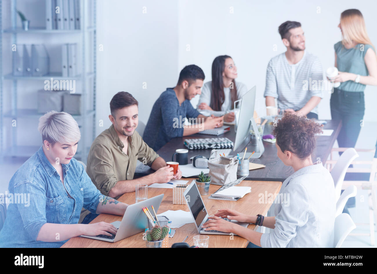 Multicultural employees enjoying their coffee break at work Stock Photo ...