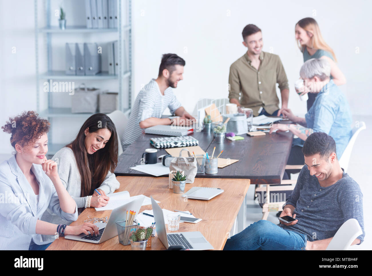 Culturally diverse team of employees enjoying their time on a break ...