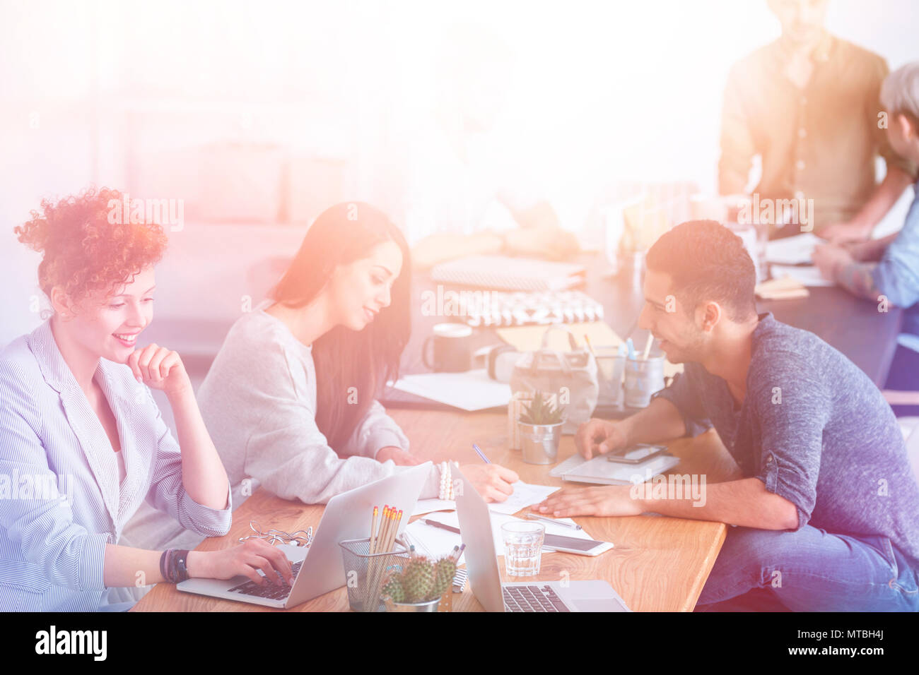 Coworkers enjoying themselves in the office while having a break from ...