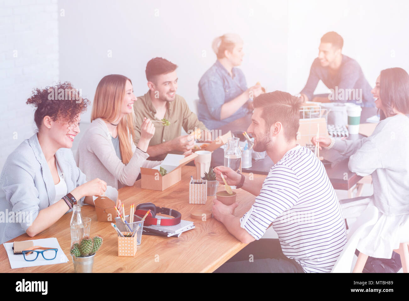 Employees enjoying their lunch and talking to each other Stock Photo ...