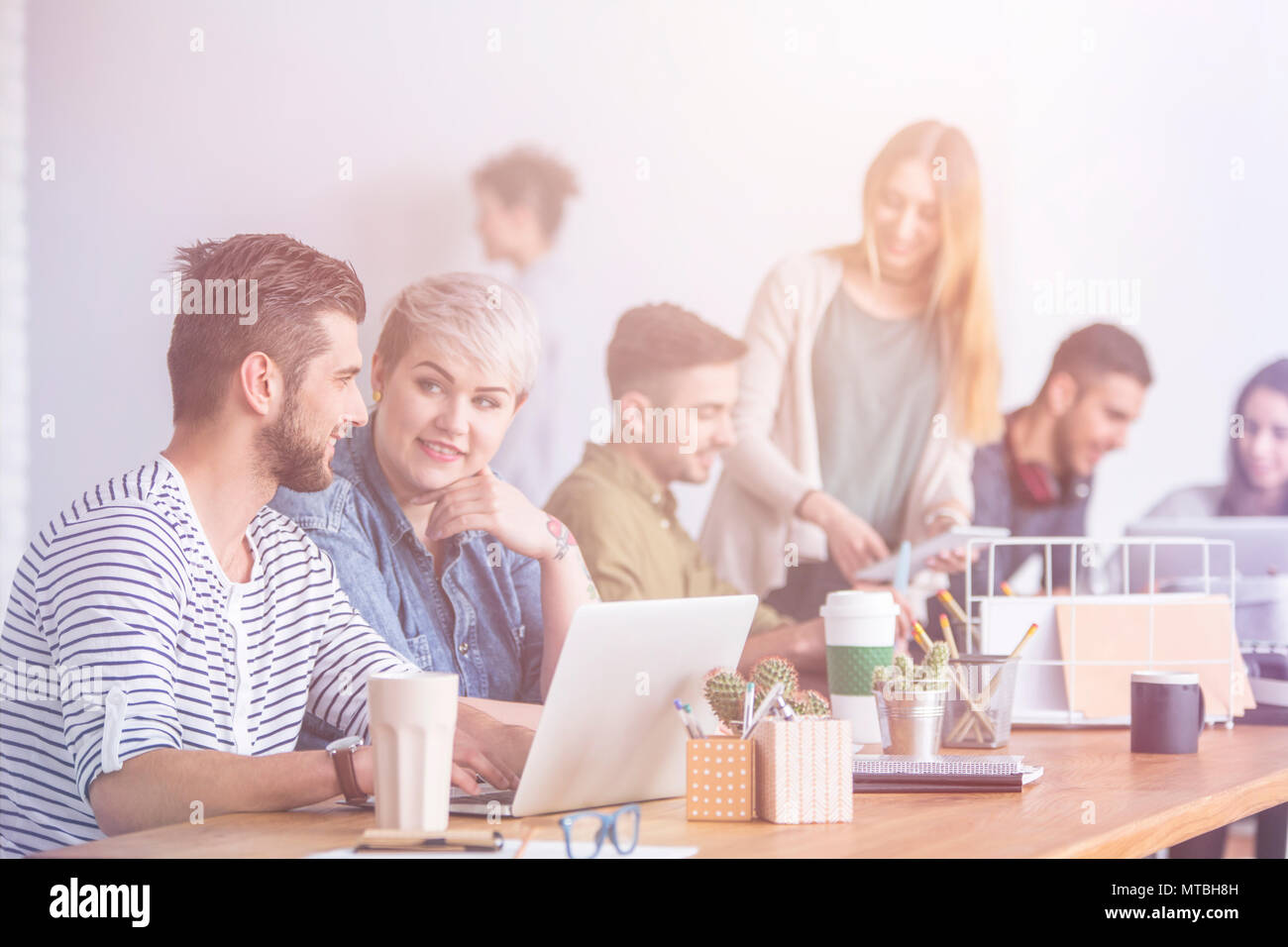 Polite conversation between caucasian colleagues in a modern office ...