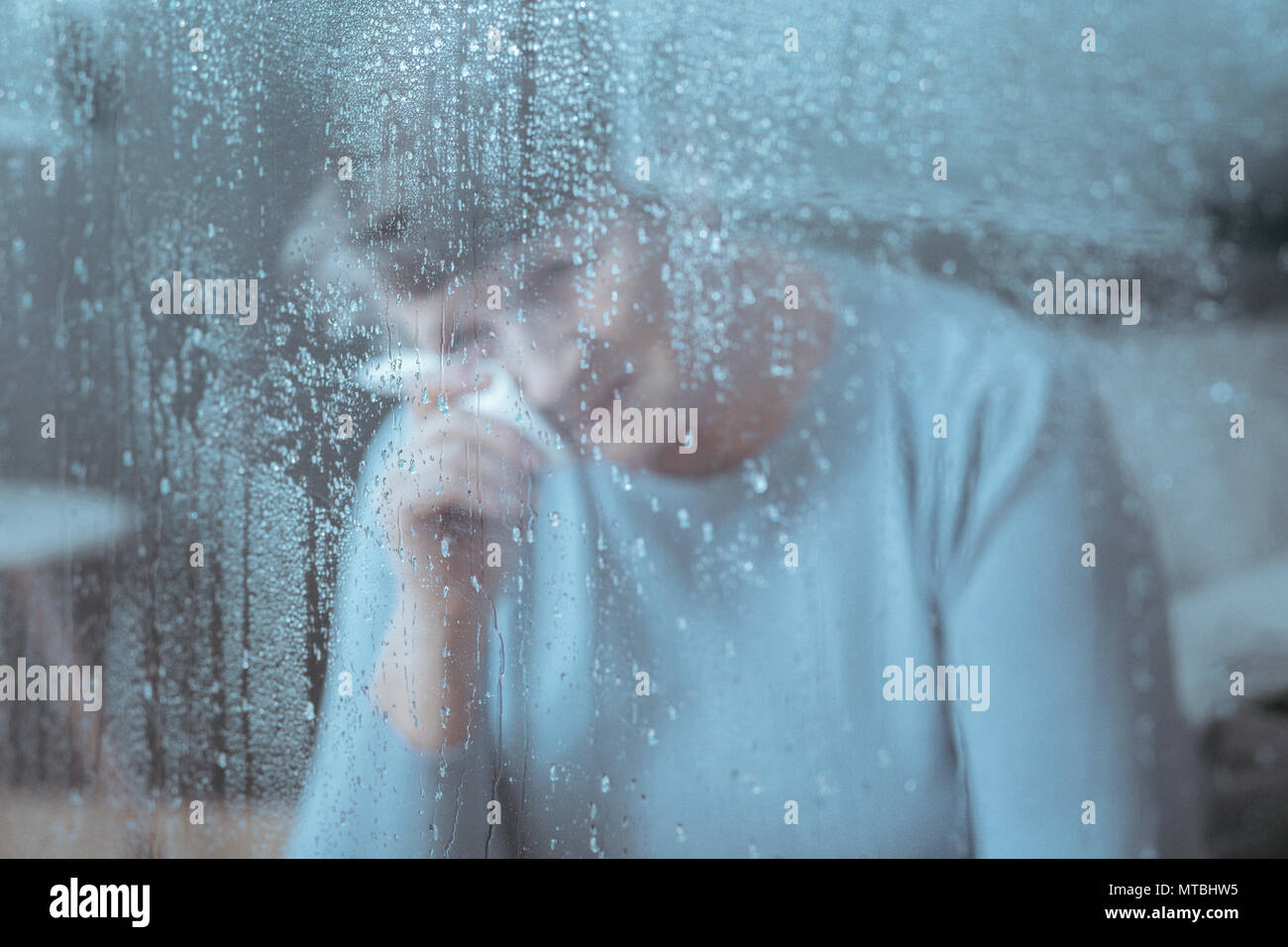 Image of sad, older woman crying, holding tissue Stock Photo - Alamy