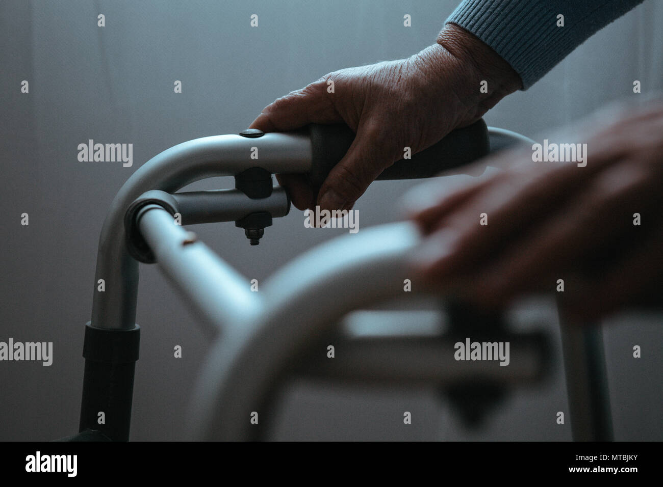 Disabled person holding hands on walker, close up Stock Photo - Alamy