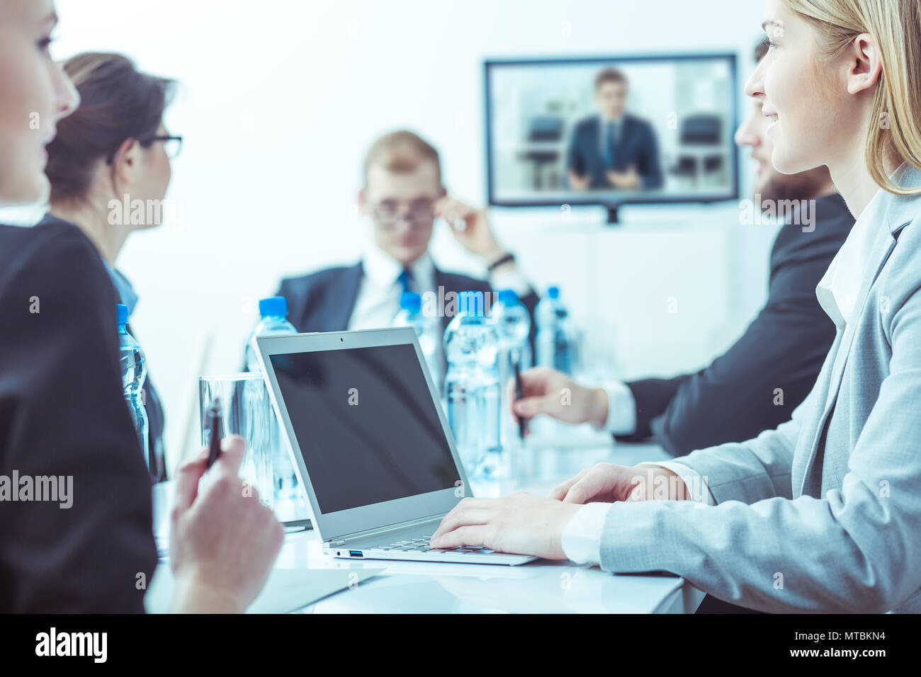 Businesspeople during video conference sitting in light office Stock ...