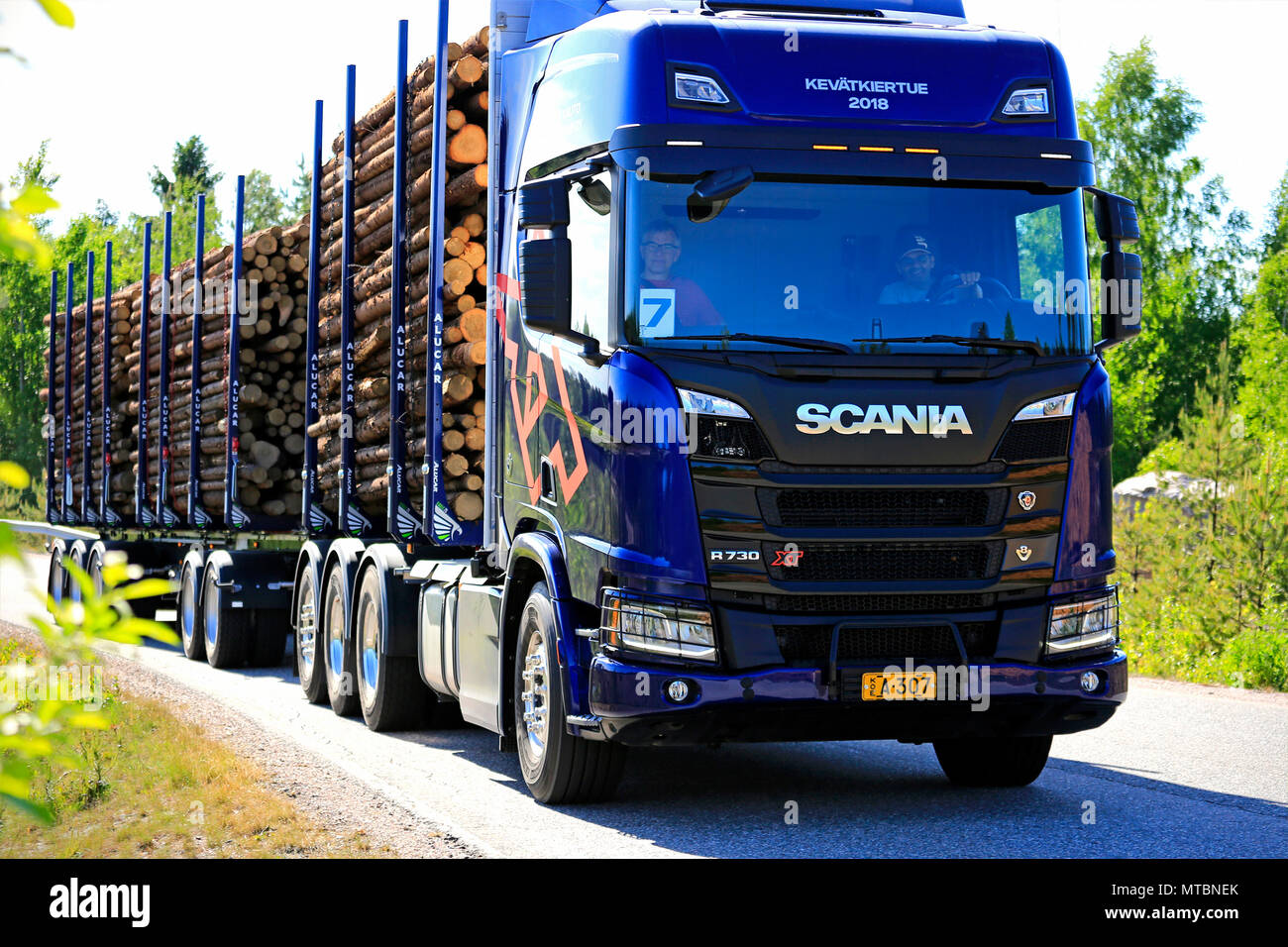 Blue Next Generation Scania R730 XT logging truck close up at speed ...